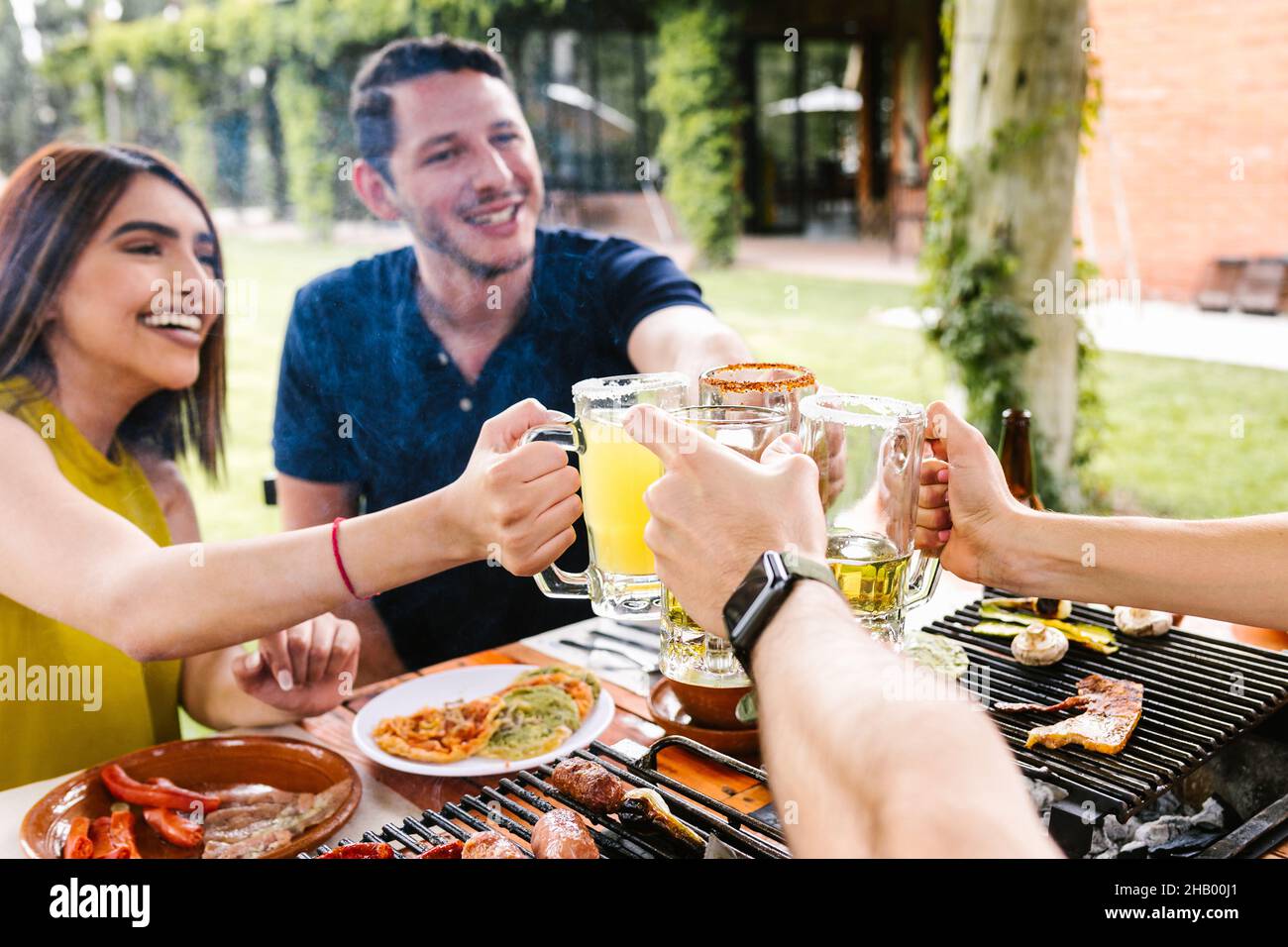 Group of young latin friends meeting for beer, michelada drinks and ...