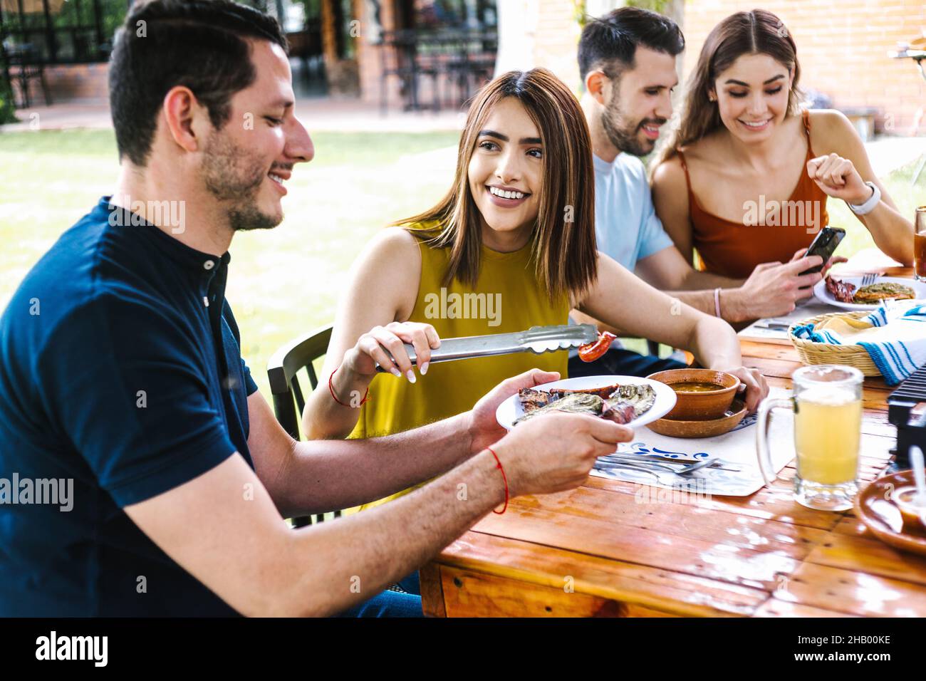 Group of latin friends eating mexican food in the restaurant terrace in ...