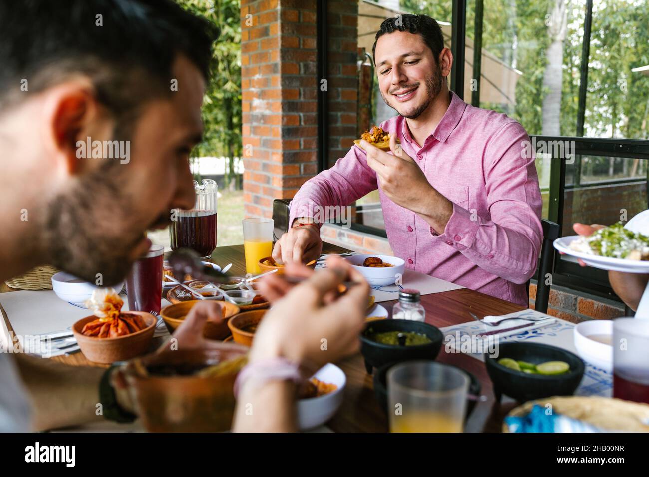 Young latin man eating mexican food tacos tostadas on a restaurant ...