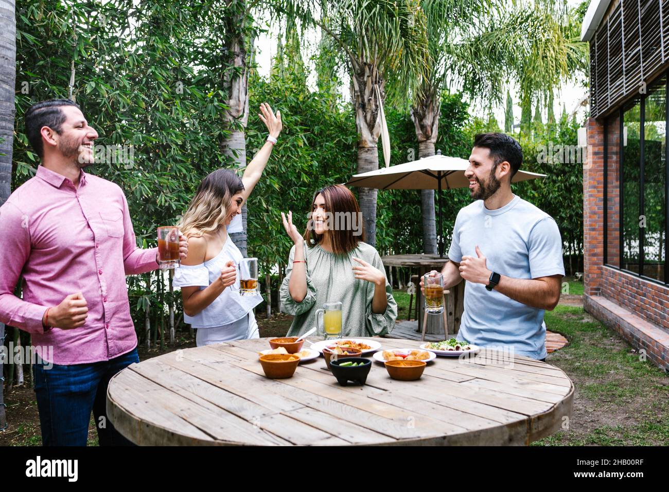 Group of young latin friends meeting for beer, michelada drinks and ...