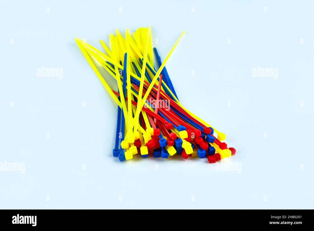 Multicolored cable clamps on a white background in the center of the ...