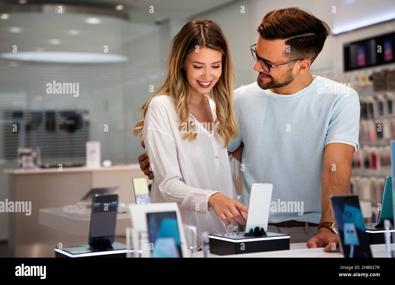 Tech shopping device gadget concept. Happy young people buying a new ...