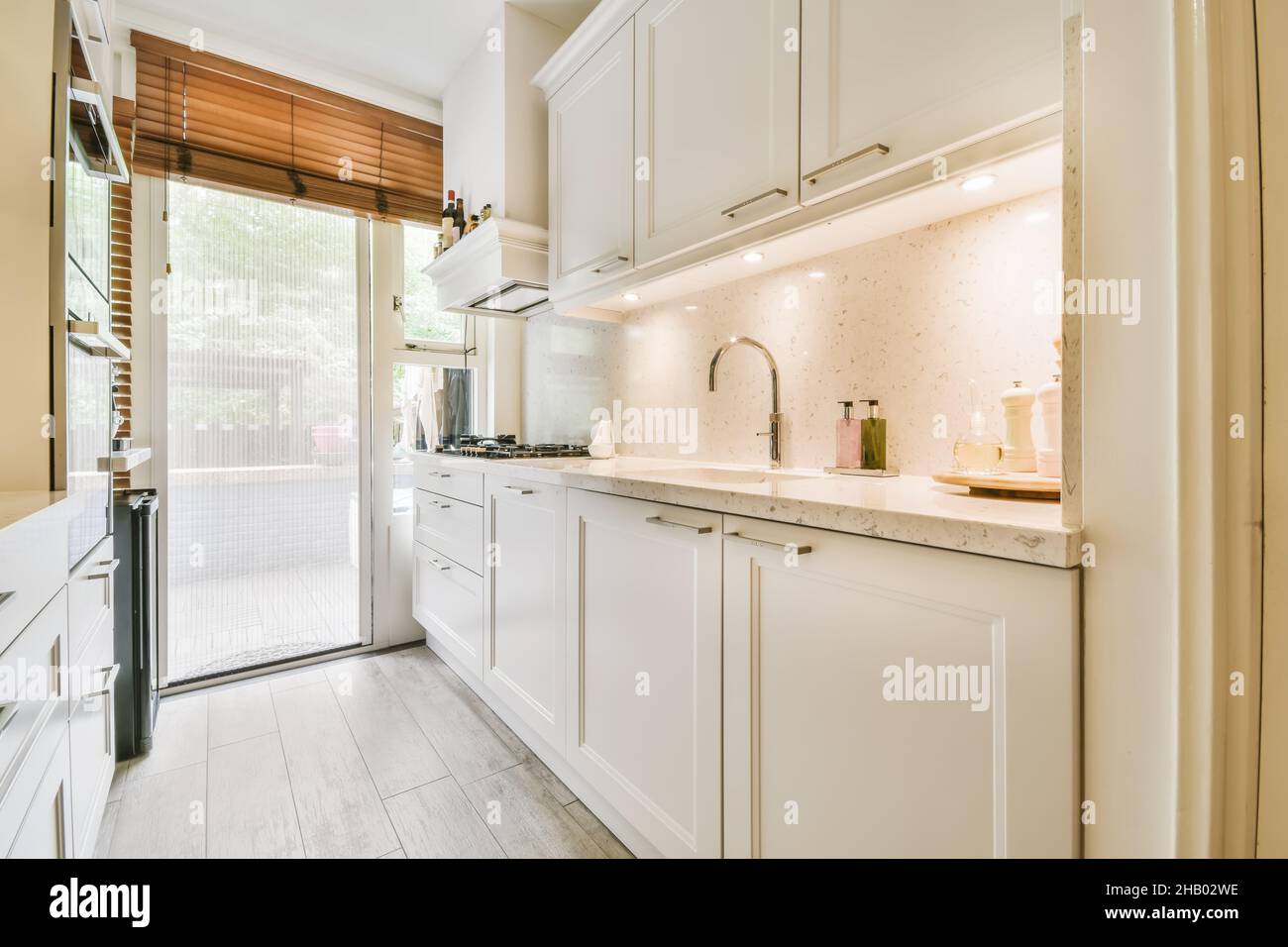 Long narrow kitchen with kitchen units on both sides Stock Photo - Alamy