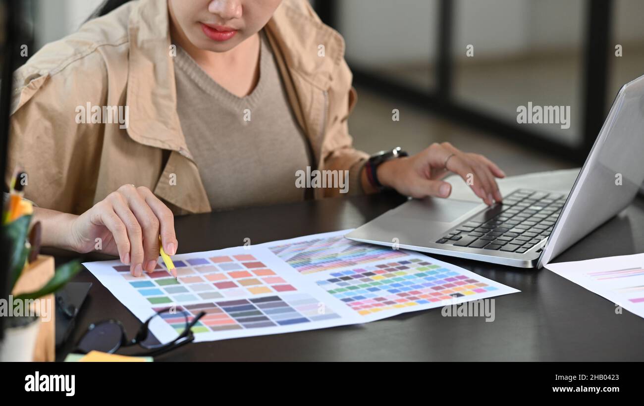 Cropped shot graphic designer woman working with color palette at ...