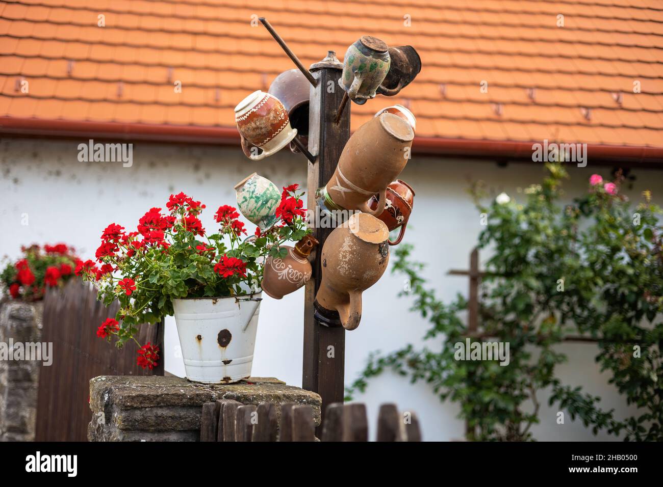 Several ceramic cups stored hanging on a fence in village in Hungary ...