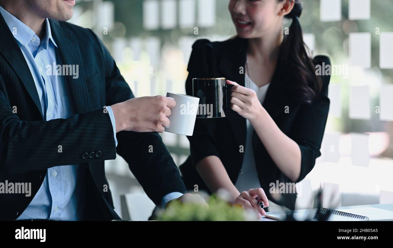 Successful business people clinking cups of coffee for celebrating ...