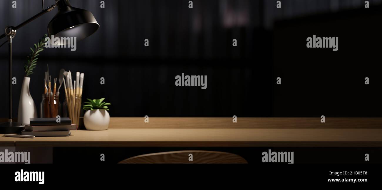 Modern dark workspace with painting tools, books, decor, table lamp and ...