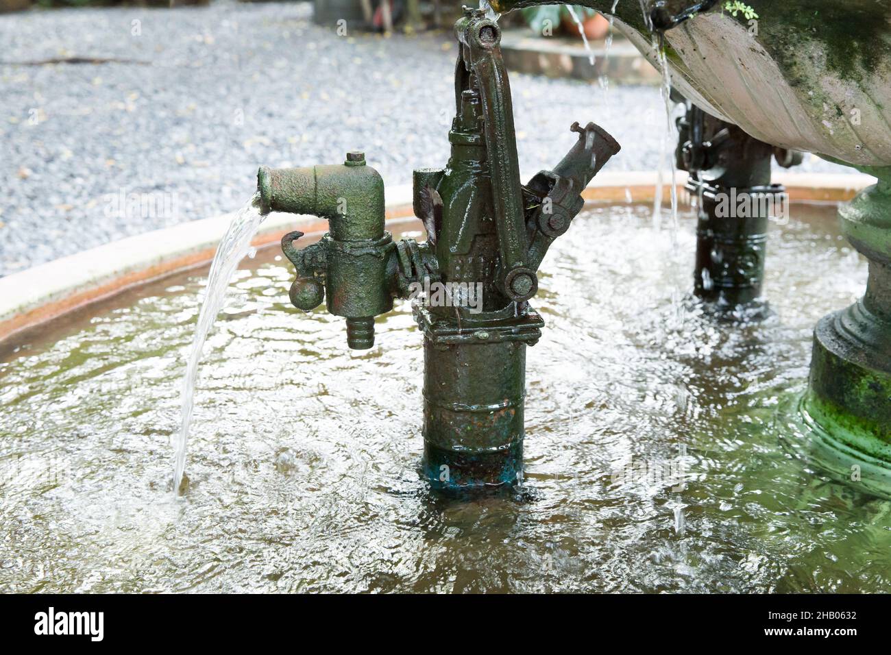 Vintage rusty water fountain hand pump and many Moss Stock Photo - Alamy