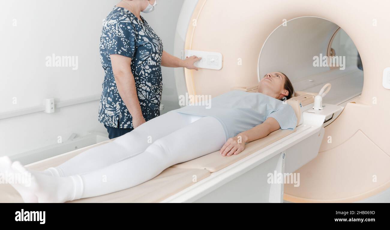 Doctor or nurse and patient with tomography CT or MRI Scan in hospital ...