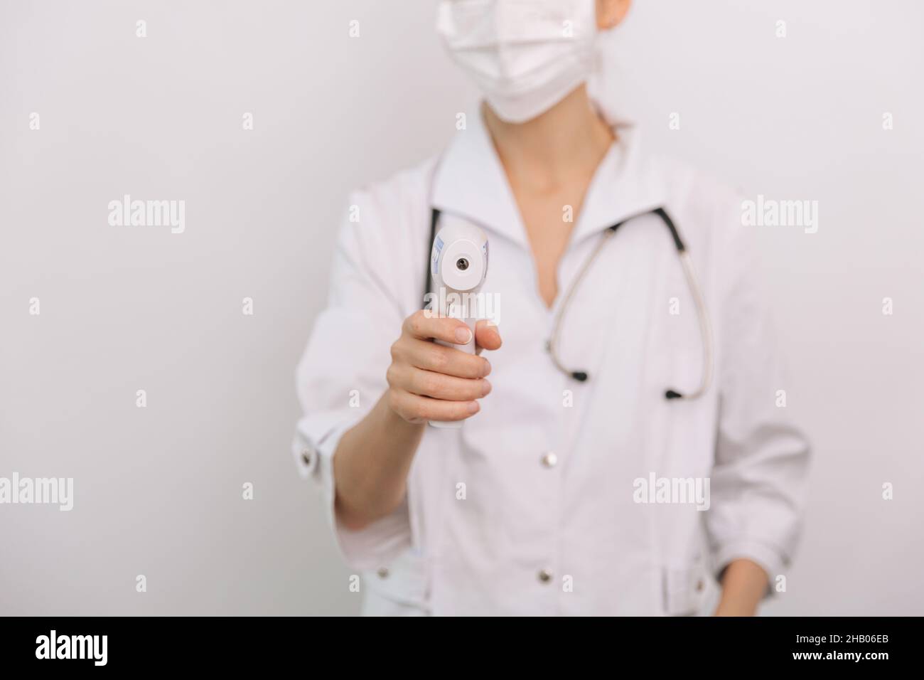 Temperature measurement gun in doctor hands. Close-up shot of doctor ...