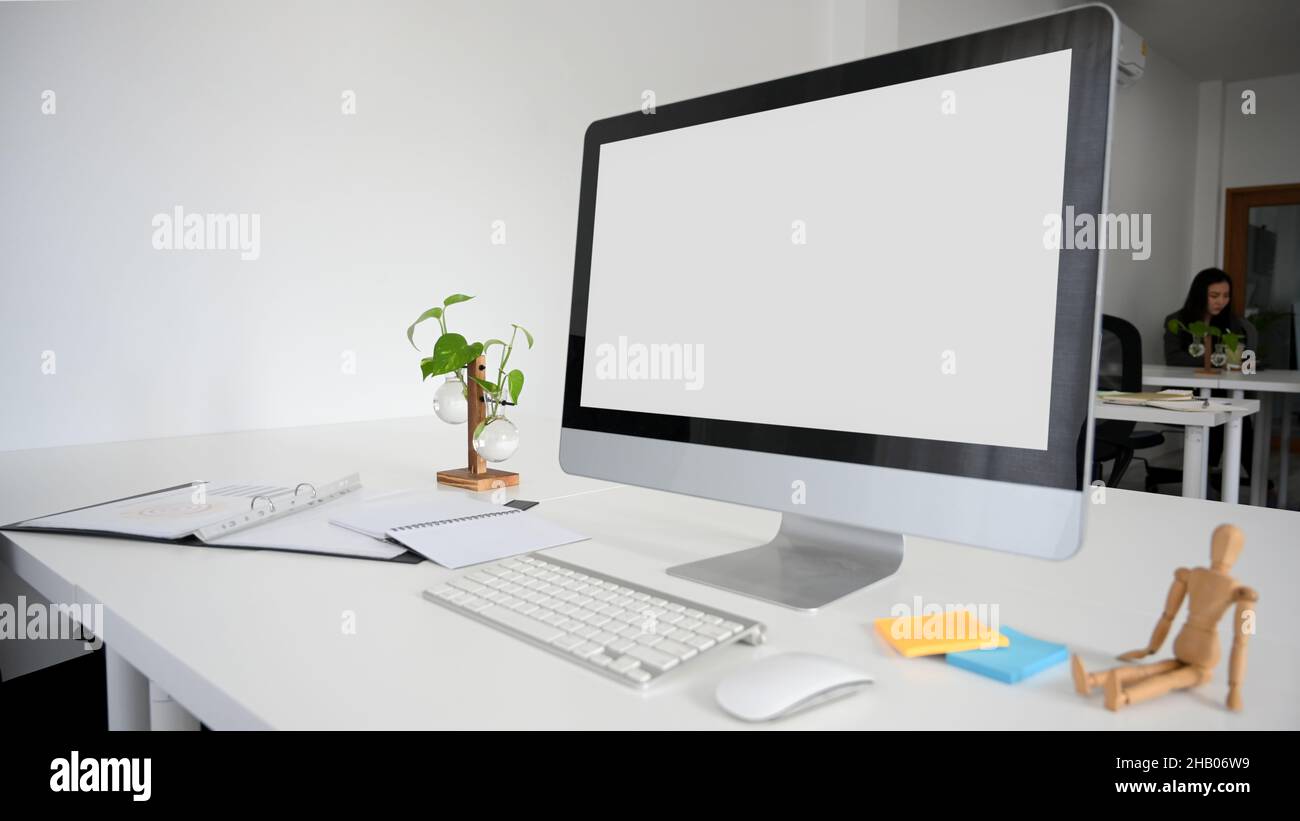 Modern office desk with desktop computer white screen mockup and office ...