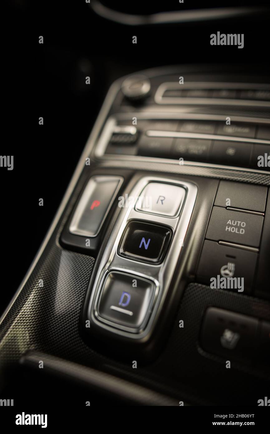 Close up shot of an automatic button gear shifter on a central console ...