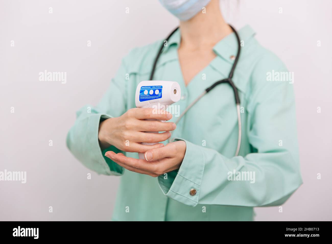 Temperature measurement gun in doctor hands. Close-up shot of doctor ...