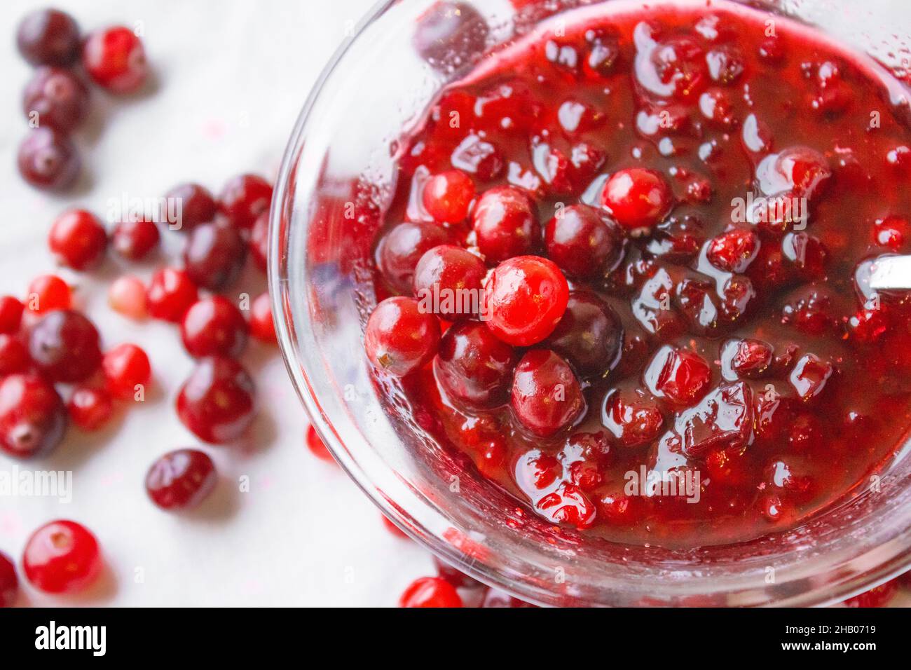 Berry jam with berries close-up on a white tablecloth Stock Photo - Alamy
