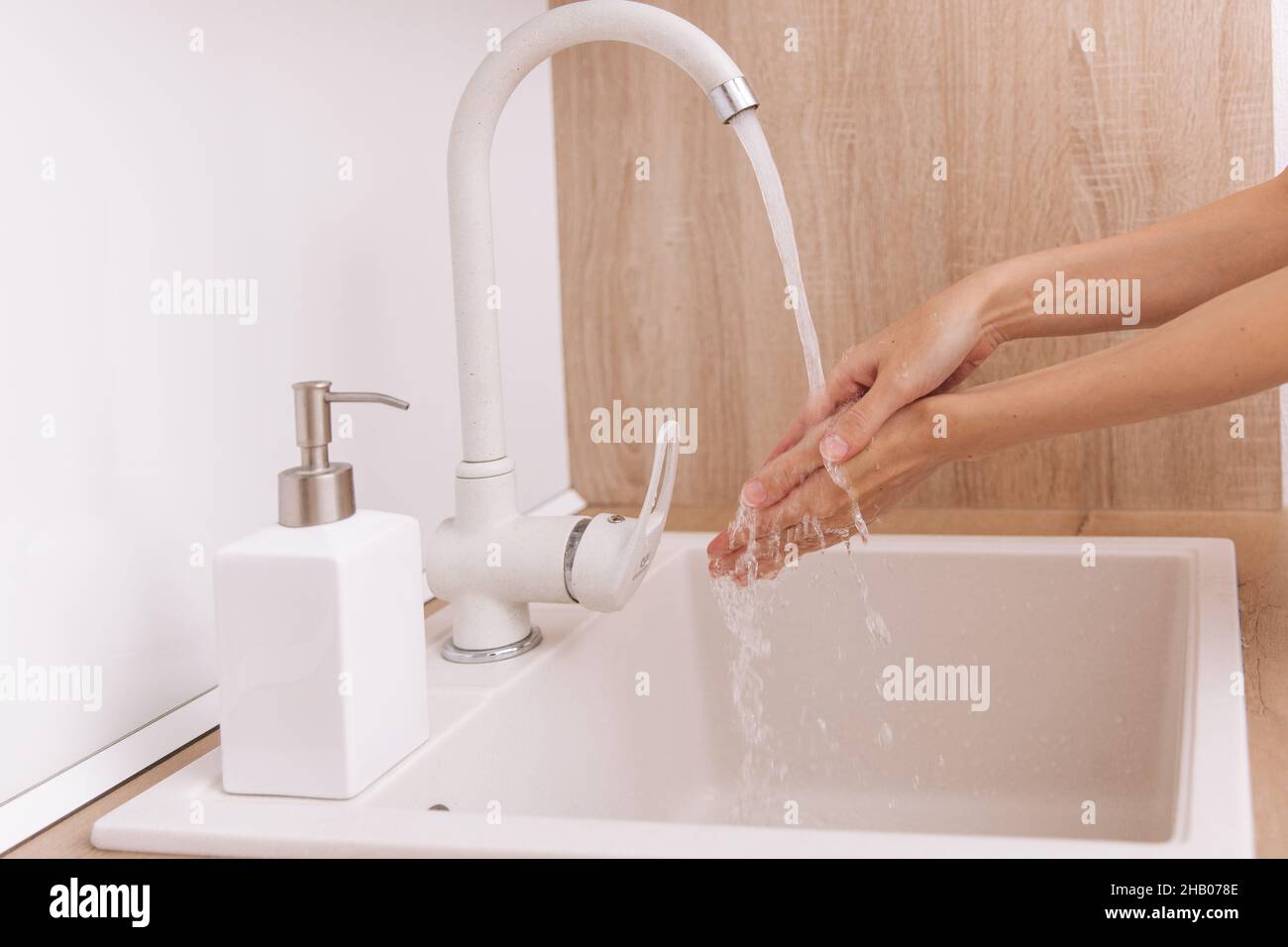 Washing hands under the flowing water tap. Washing hands rubbing with ...