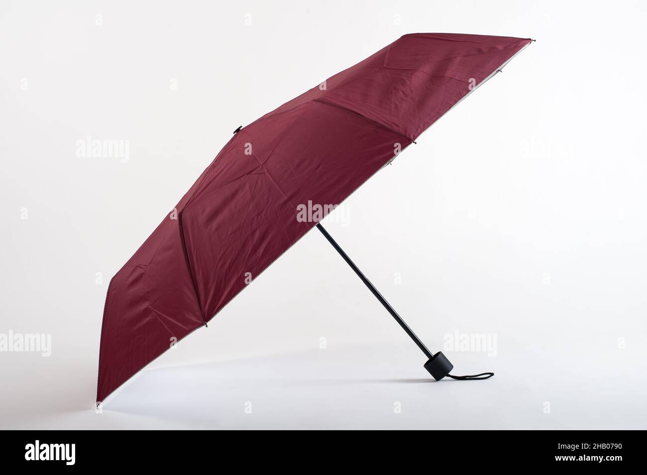 Opened maroon umbrella isolated on white background. Studio shoot Stock ...