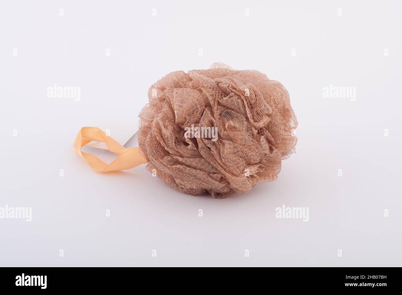 Soft brown bath puff or sponge isolated on white background. Studio ...