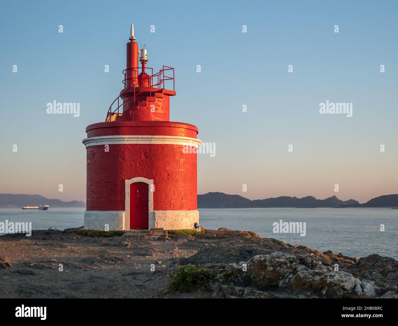 Beautiful view of a Punta Robaleira red lighthouse in Donon, Spain with ...