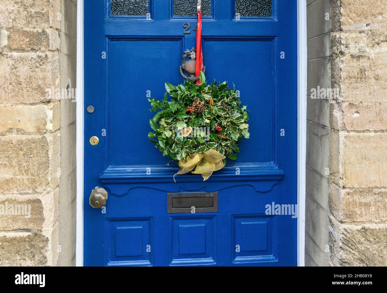 Colourful Christmas wreath on a house front door in the market town of ...