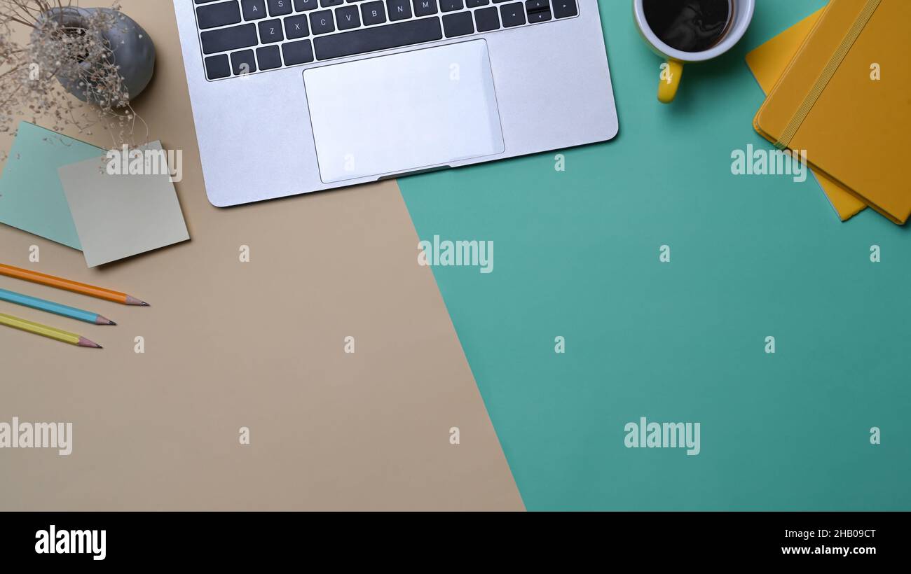 Computer laptop, coffee cup, sticky notes and stationery on colorful ...