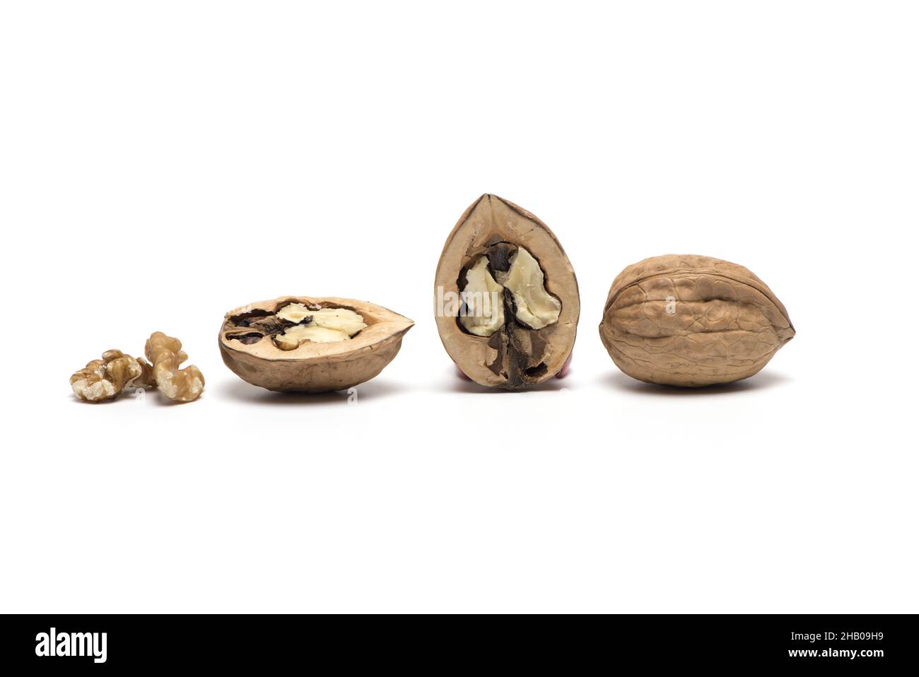 three walnuts one closed two halves side by side seen outside and ...