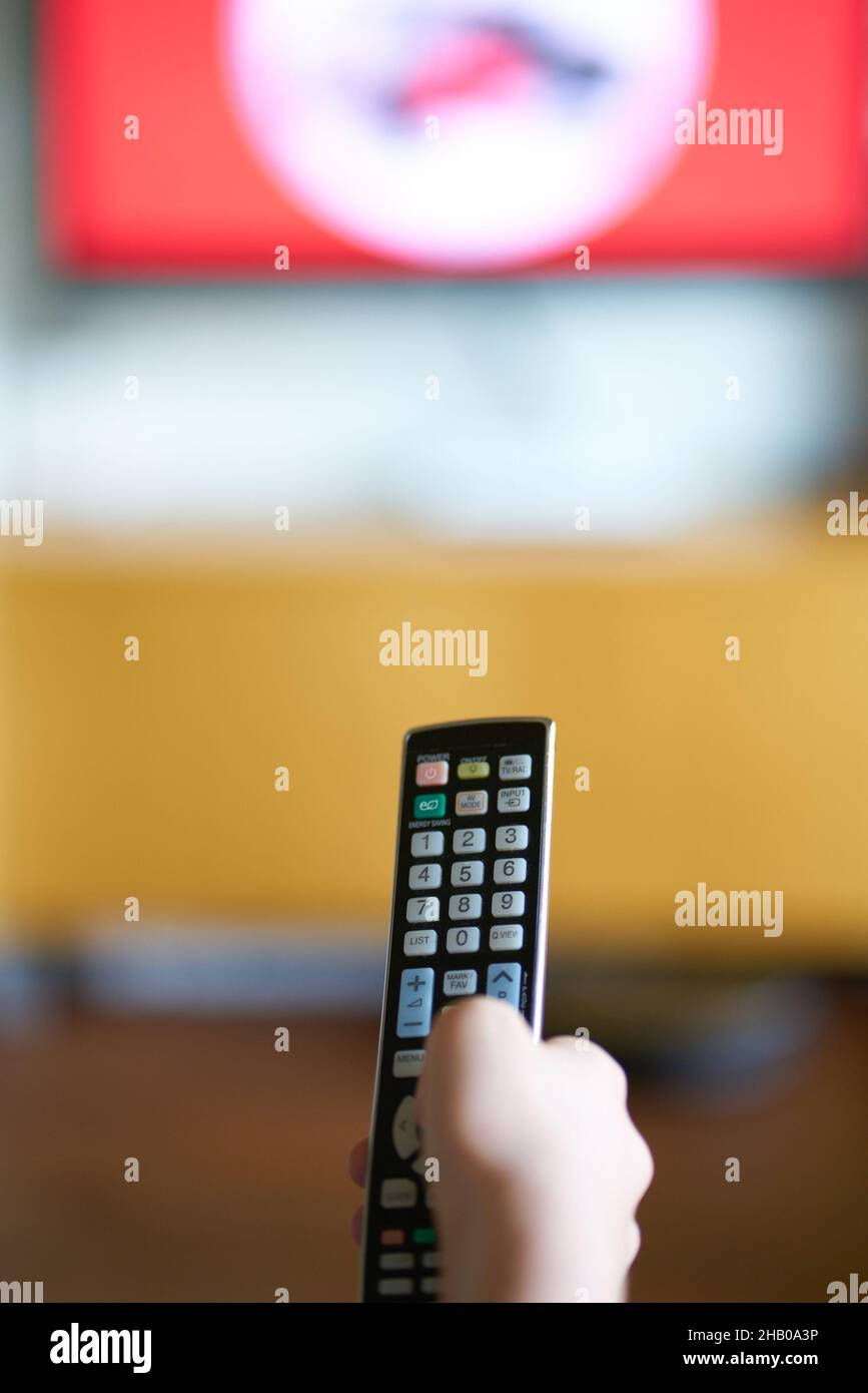 kids hand holding a TV remote controller Stock Photo - Alamy