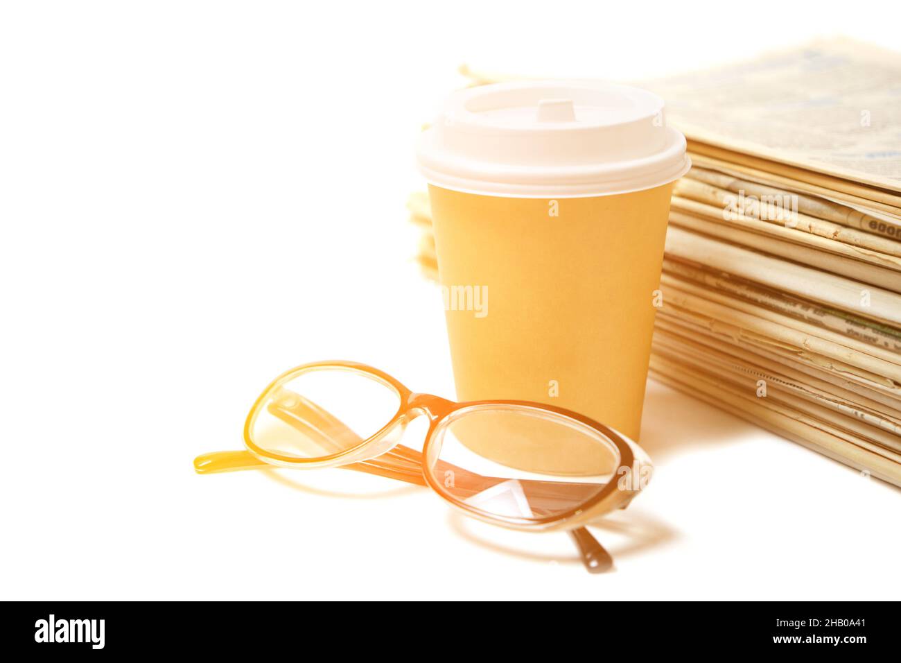 Stack old newspapers, glass of coffee and glasses for reading newspaper ...