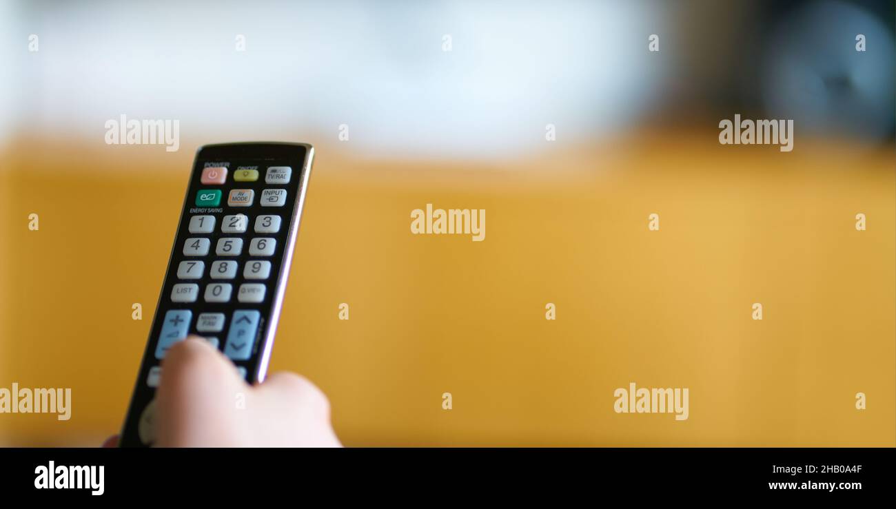child hand holding a TV remote controller Stock Photo - Alamy