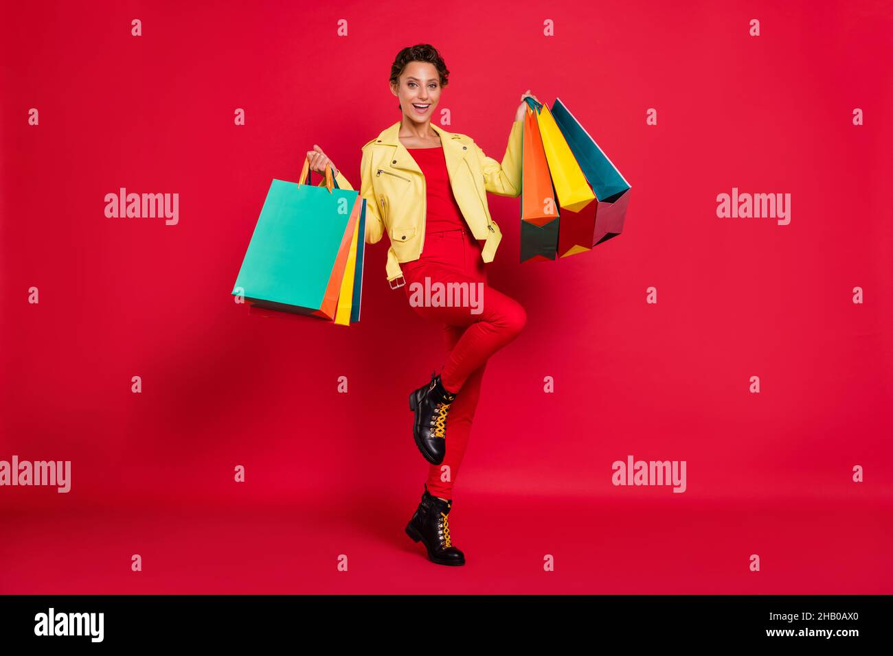 Full body photo of cool lucky charming woman hold hands purchases bags ...