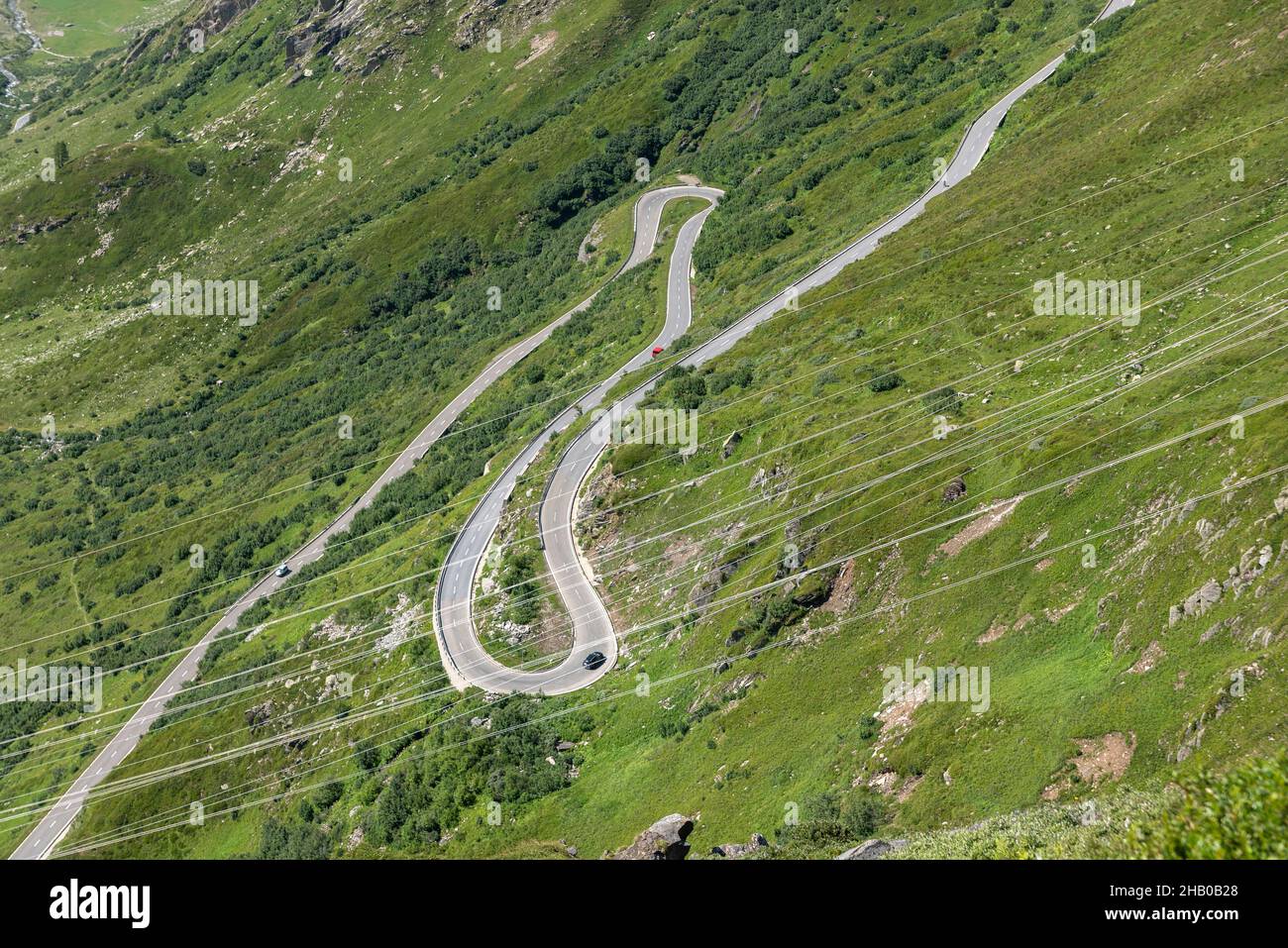 Power lines cross the Nufenenpass road, Ulrichen, Valais, Switzerland ...