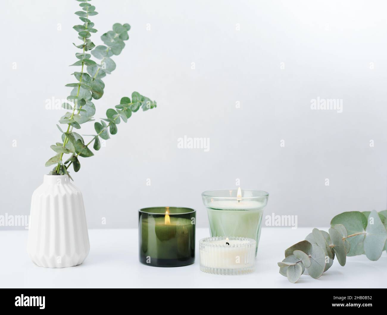 Eucalyptus branches bouquet in vase and Aromatic home perfume candles ...