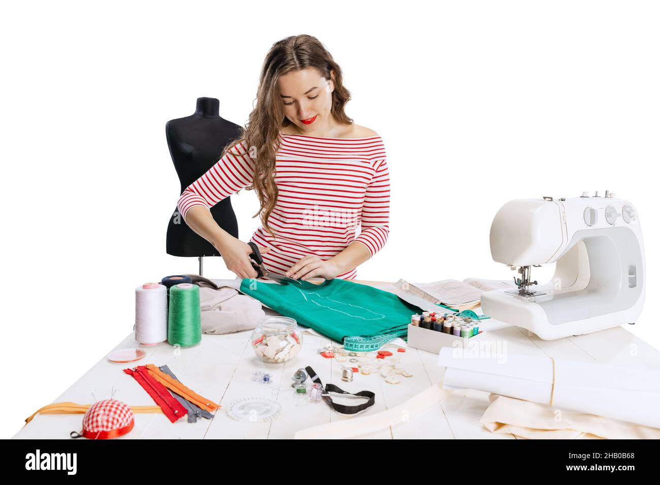 Smiling cute young girl, seamstress, dressmaker working with fabric ...