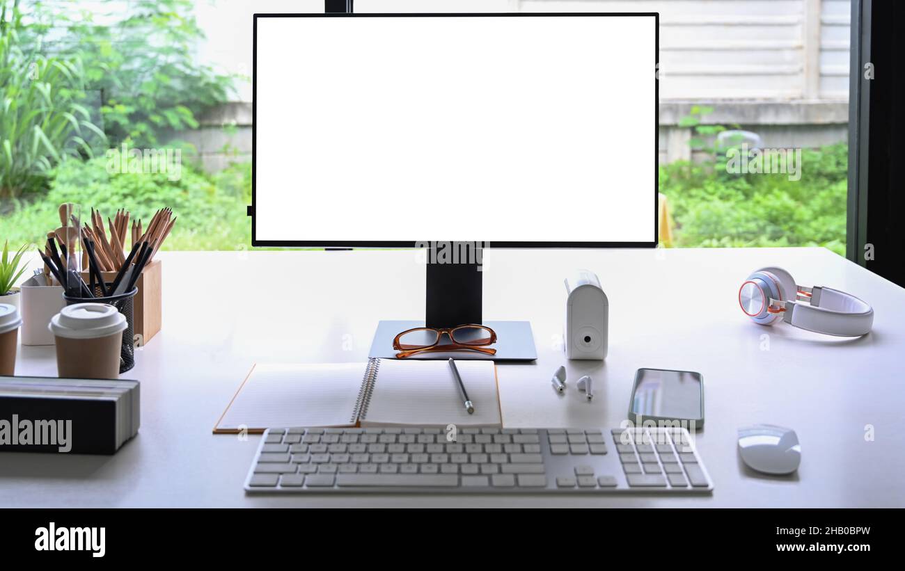 Front view computer with empty display and office supplies on white ...