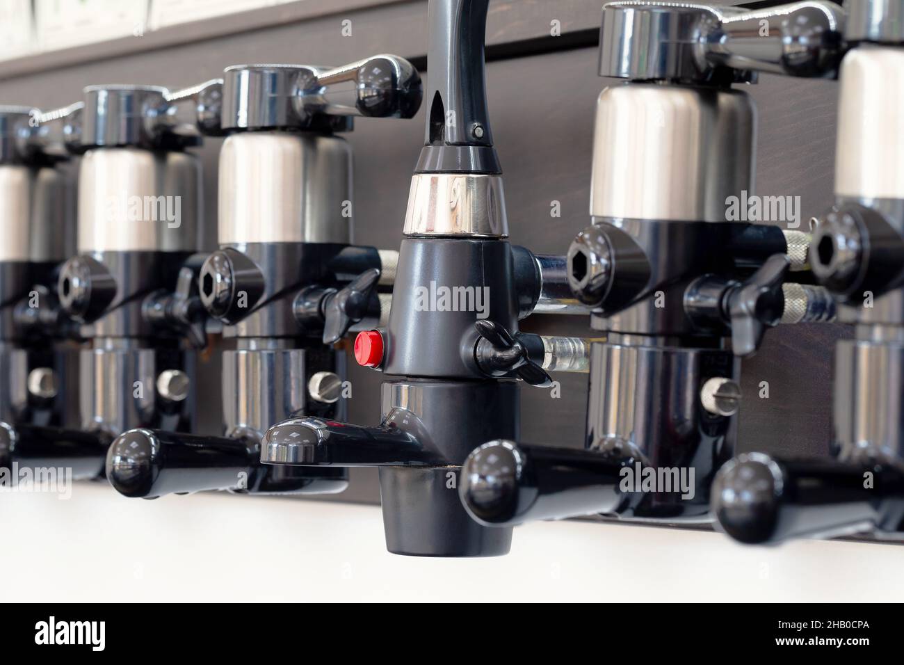 Beer taps for draught drinks are built into wooden boards in pub Stock ...