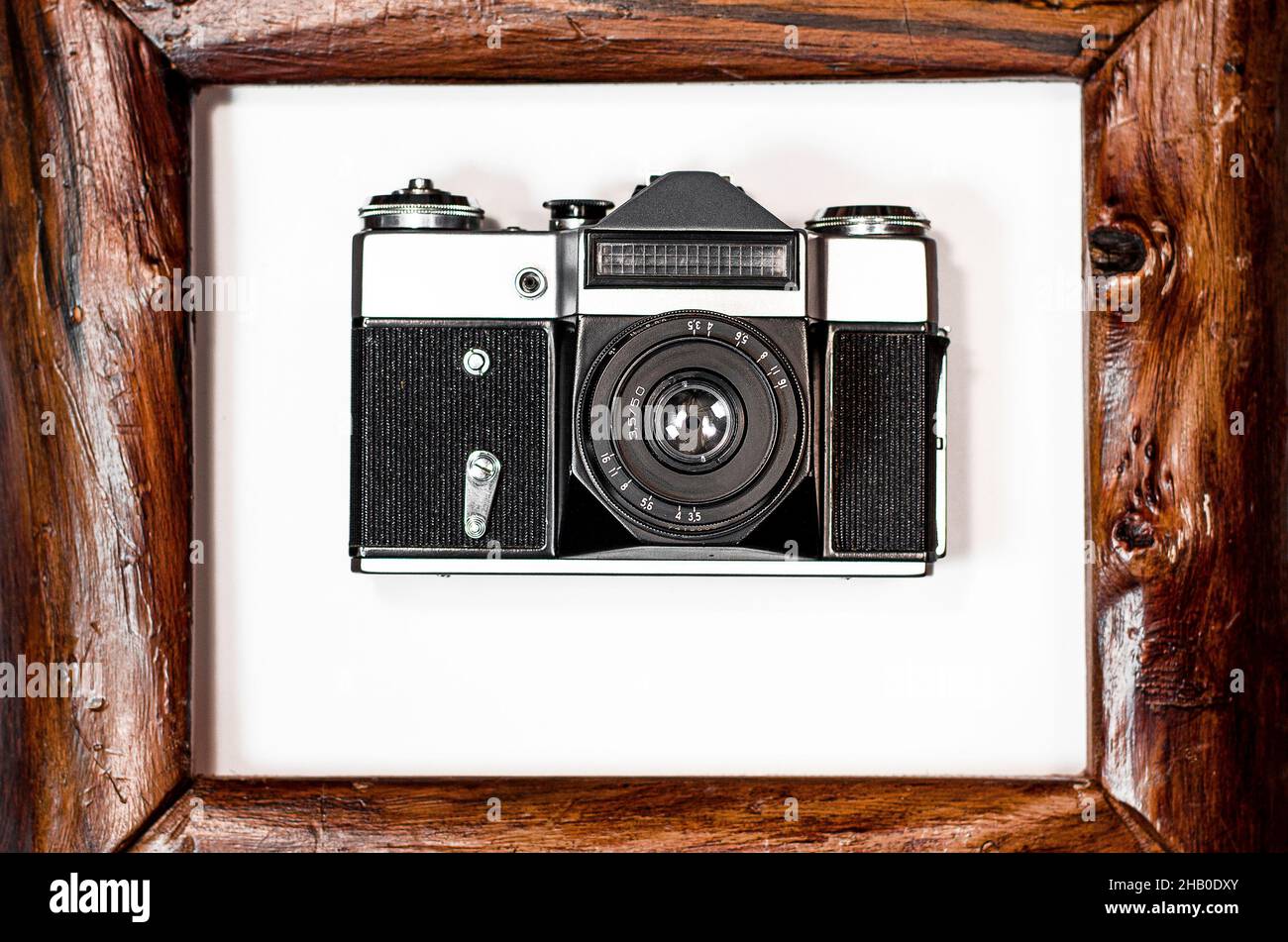 An old camera lies on a white background in a brown wooden frame. photo ...
