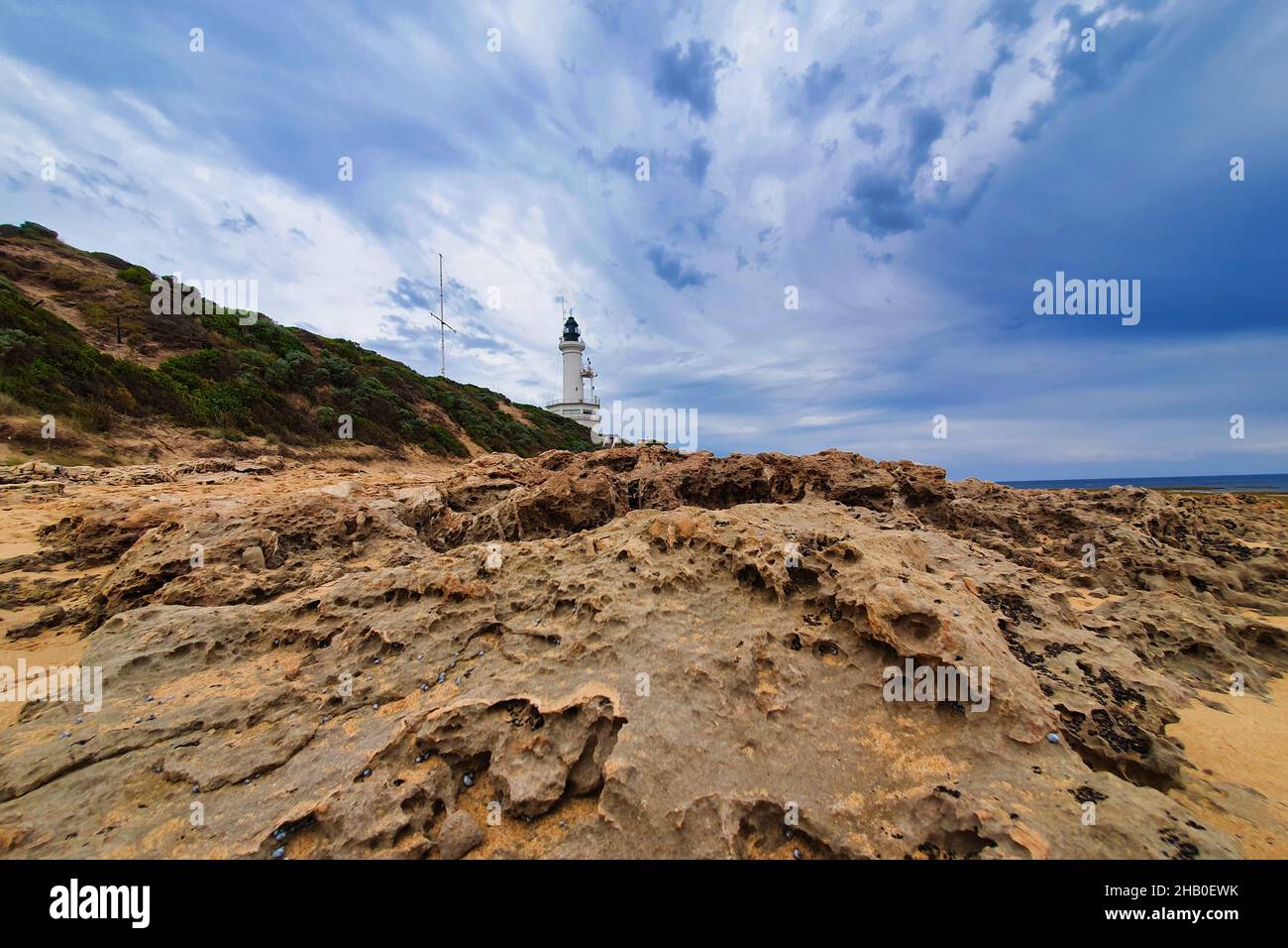 Scenic view of a lighthouse on the coast with dramatic clouds above ...