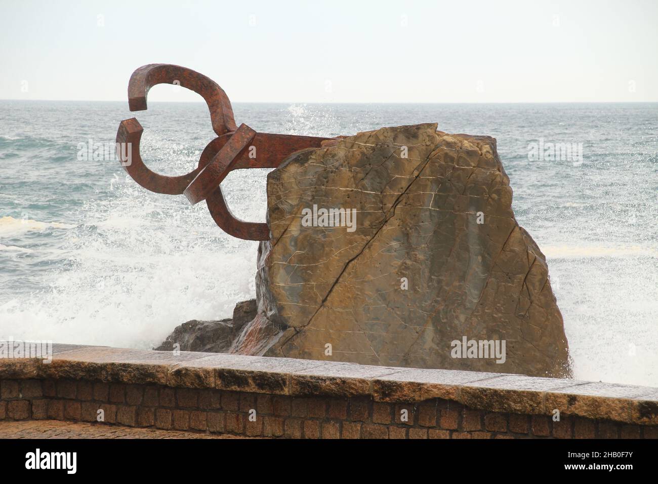 Rock with an iron structure on the coast in San Sebastian, Basque ...