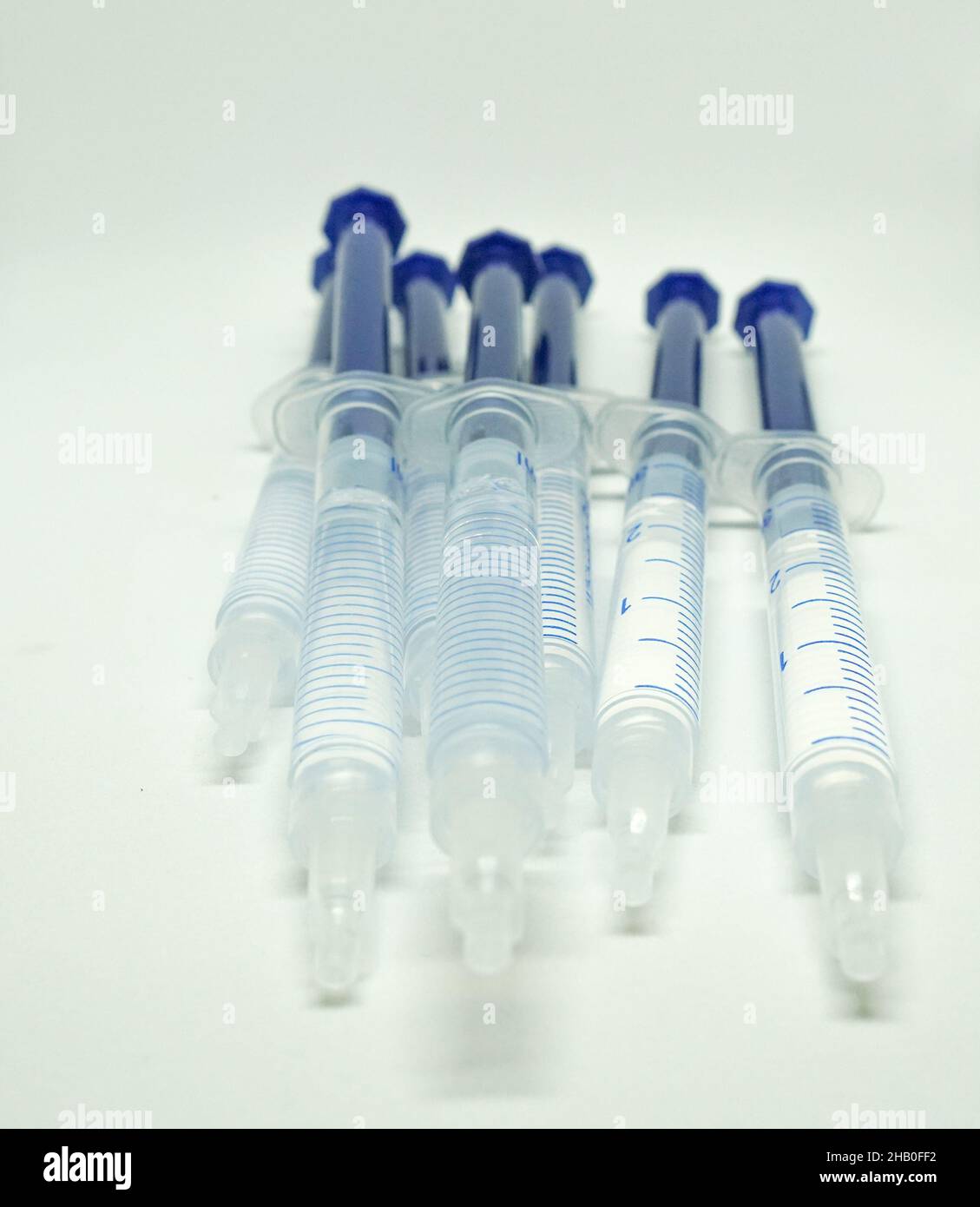 Teeth whitening syringes and tools on a white surface Stock Photo - Alamy