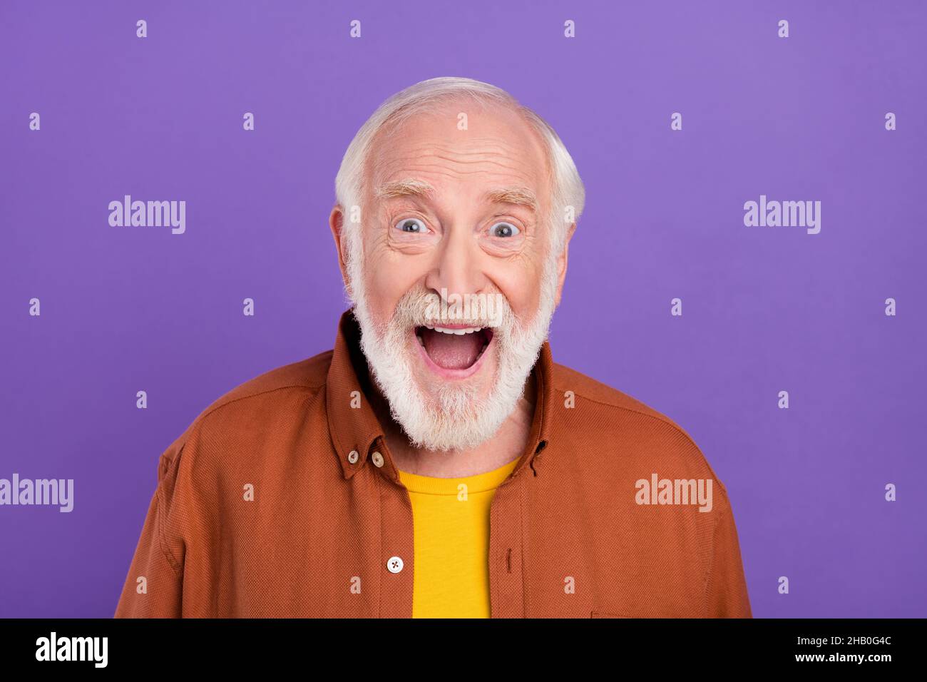 Photo of hooray aged man open mouth wearing brown shirt isolated over ...