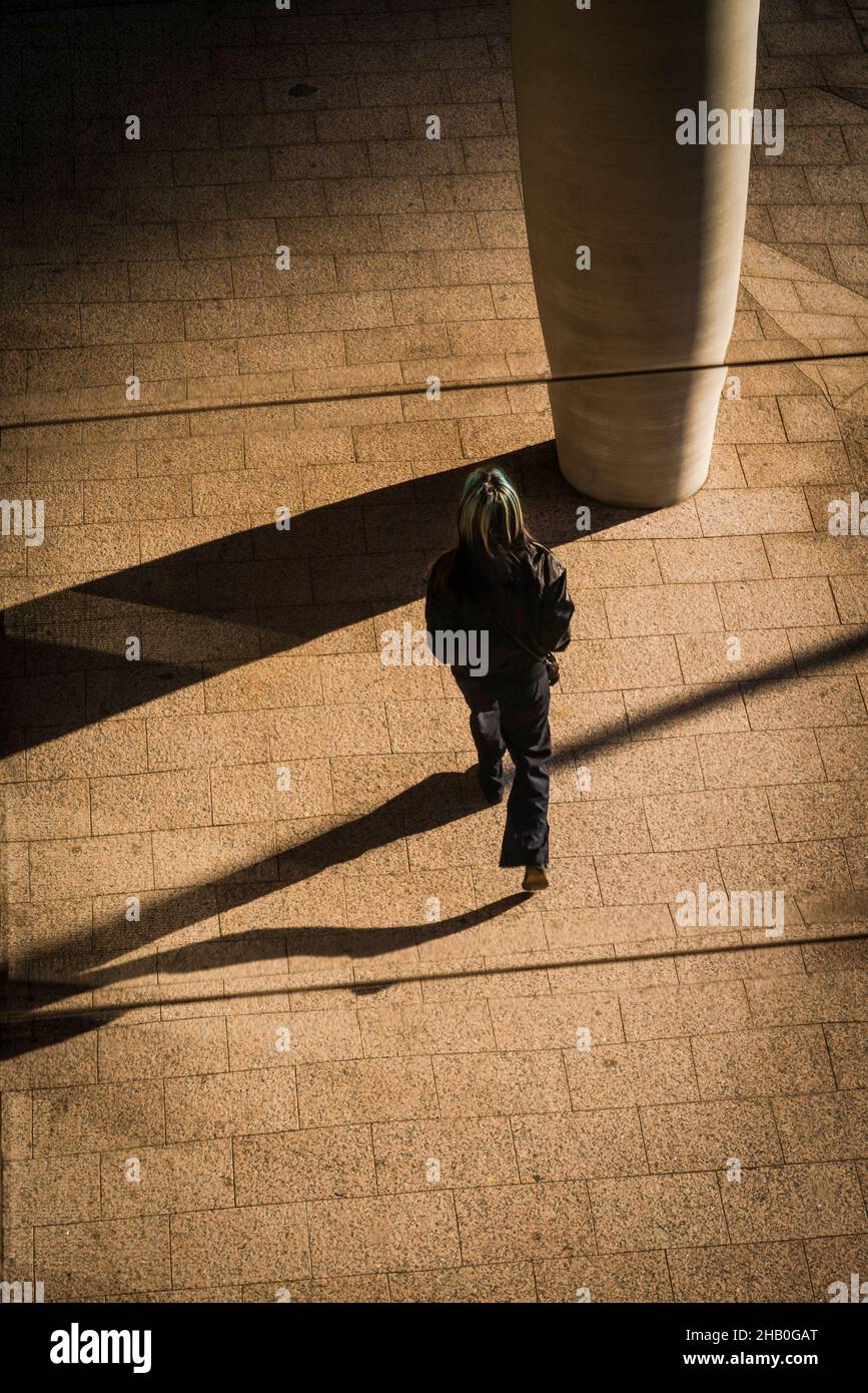 Reflection of woman walking, London, England, UK Stock Photo - Alamy