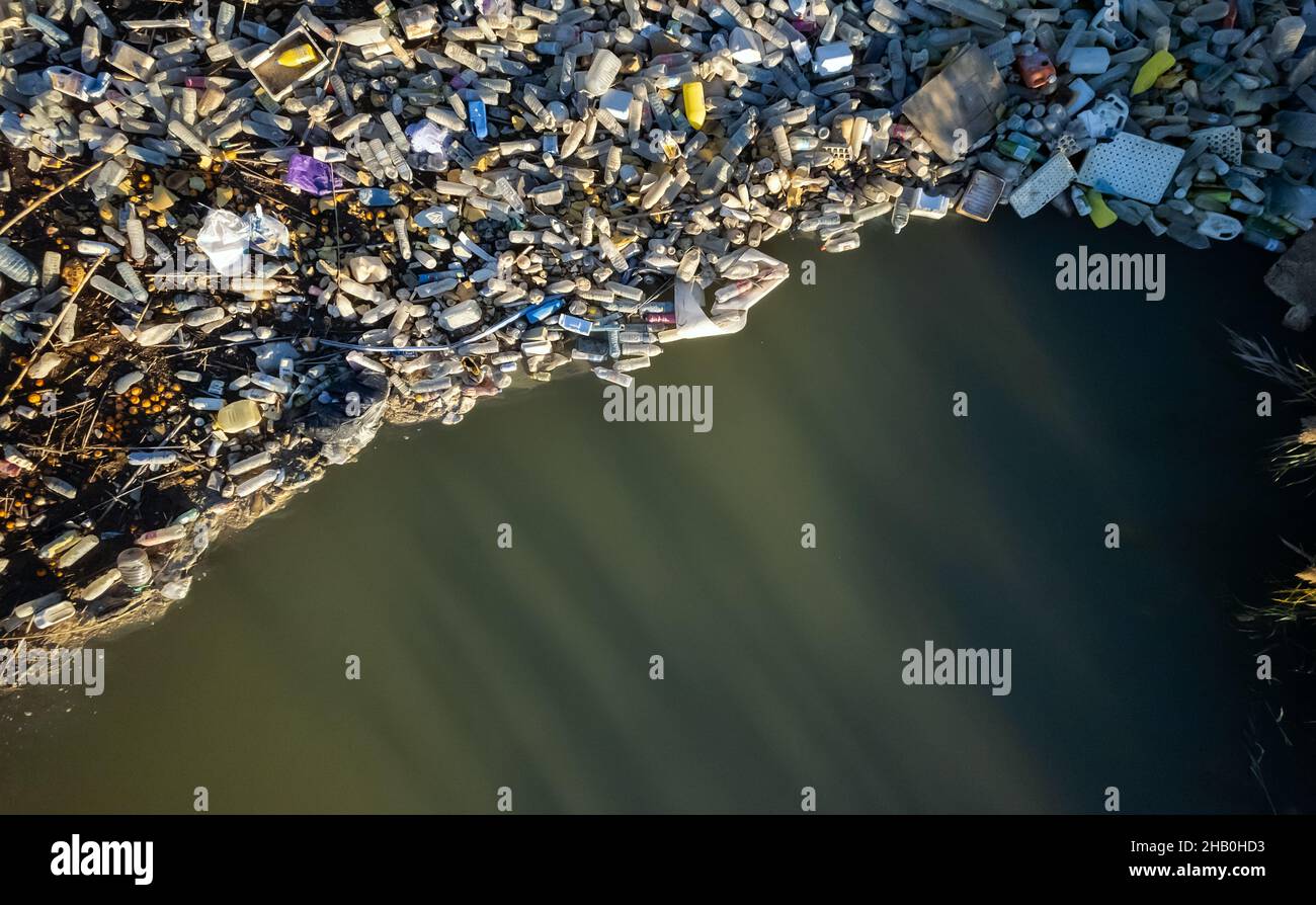 Aerial shot view waterfront scrap-heap pile plastic bottles rubbish ...