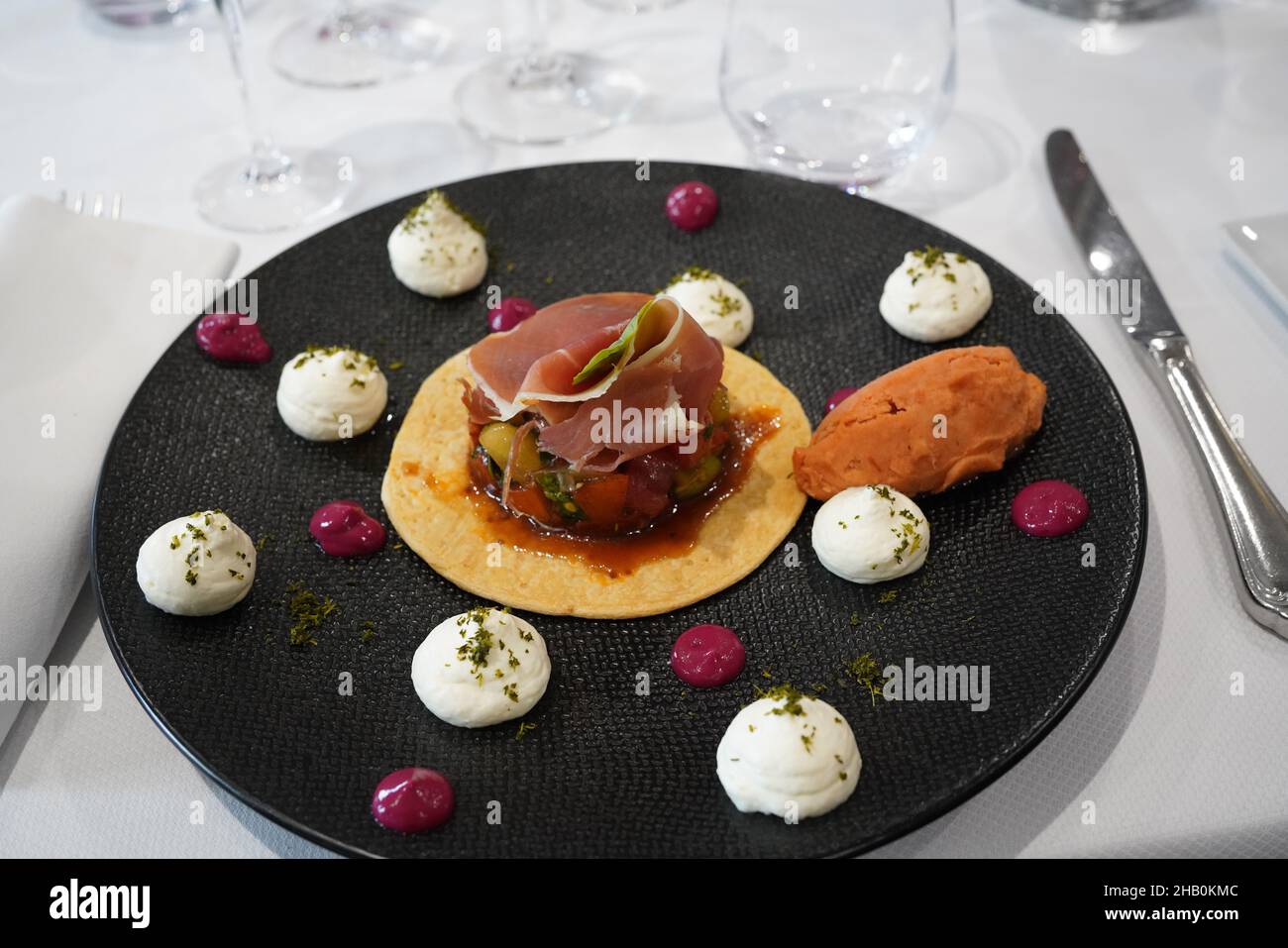 Closeup shot of an exquisite dish on a bla plate Stock Photo - Alamy