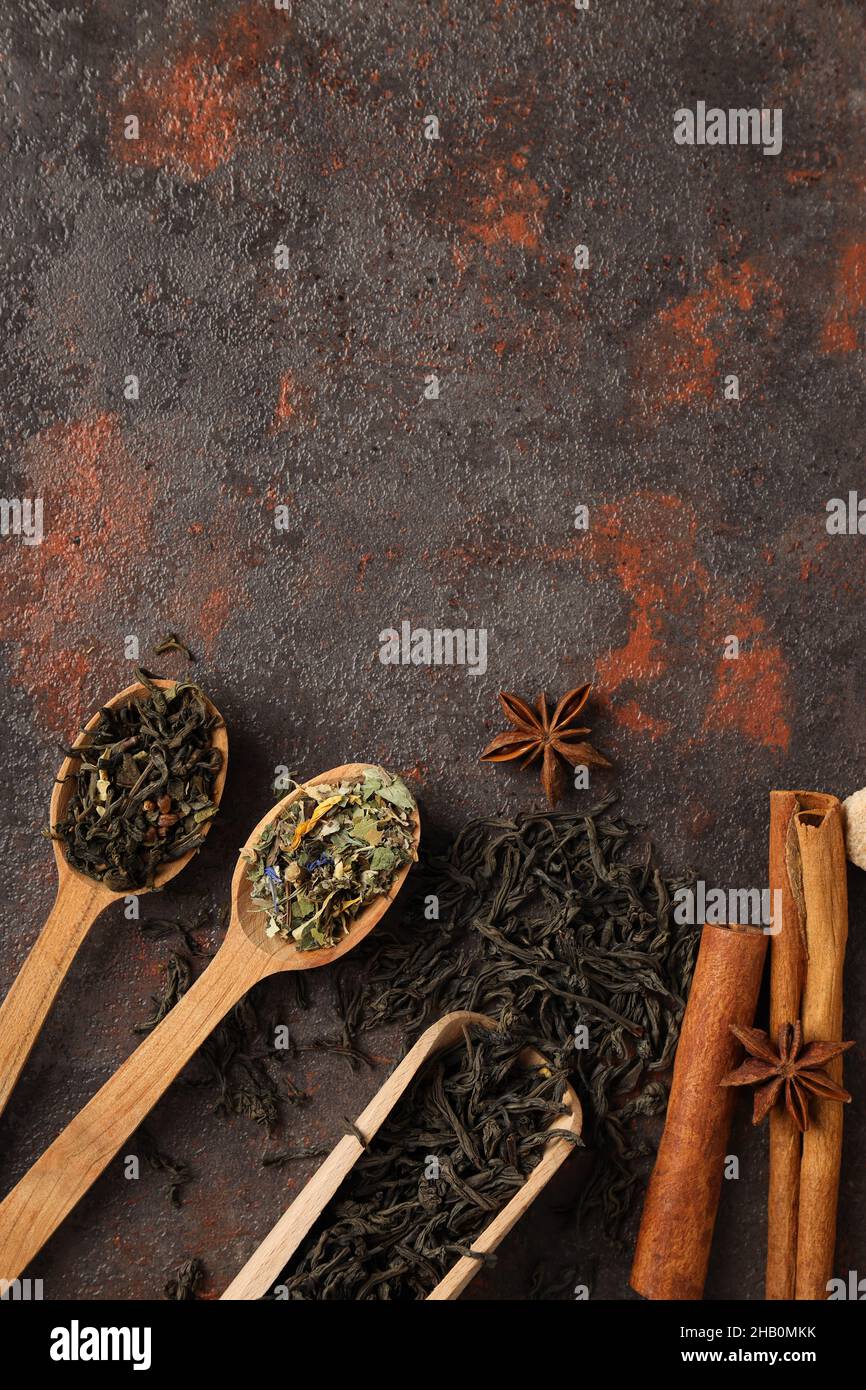 Concept of cooking tea with different types of tea on dark textured ...