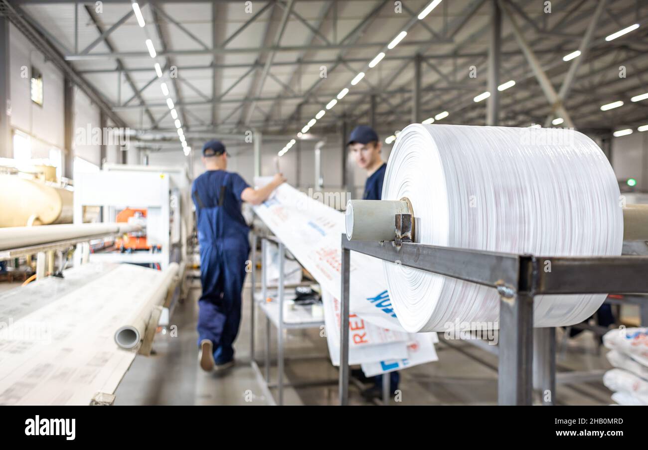 Workers in a factory carry out technological processes on a conveyor ...