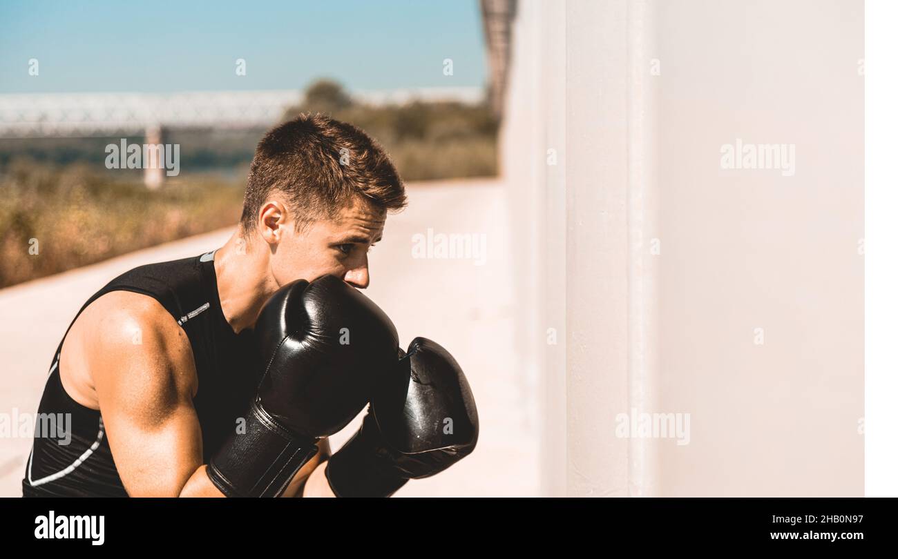 Man exercising and fighting in outside, boxer in gloves. male boxer ...