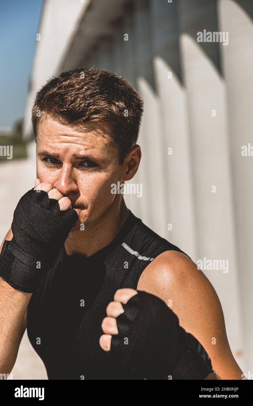 Man exercising and fighting in outside, boxer in gloves. male boxer ...