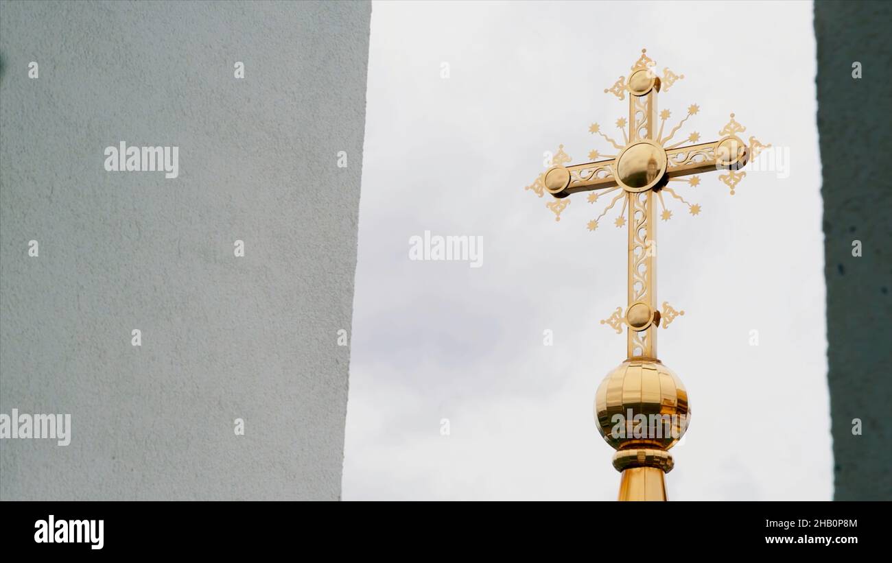 Religion and faith concept, bottom view of a golden cross of the church ...