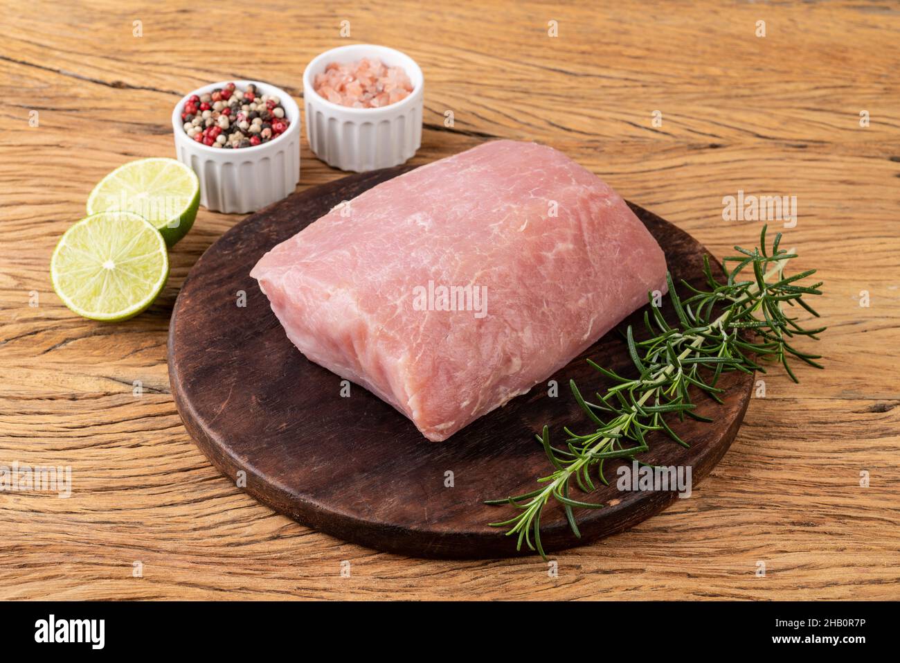 Raw pork loin meat over wooden board with seasonings Stock Photo - Alamy