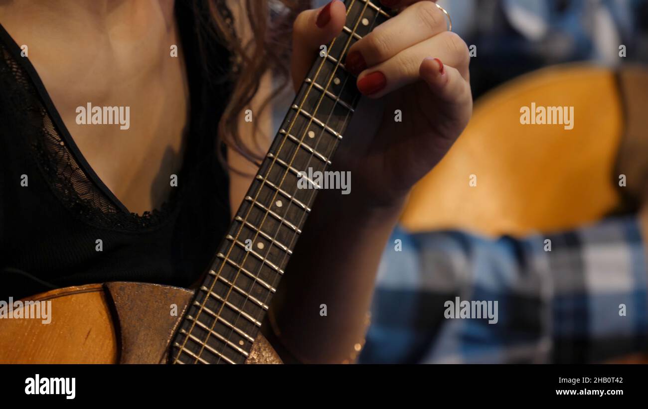 Woman playing balalaika hi-res stock photography and images - Alamy