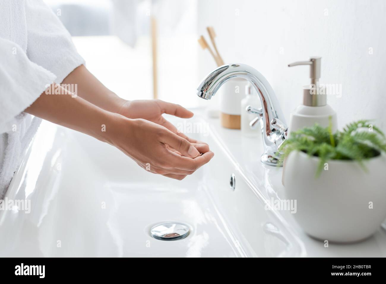 African woman washing hands hi-res stock photography and images - Alamy